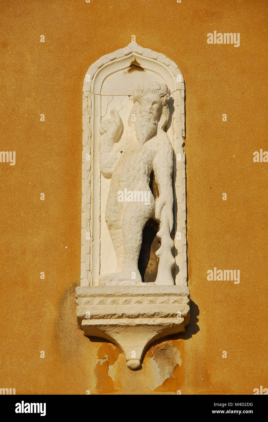 Monstrous primitive hairy man with club old medieval relief on a wall ...