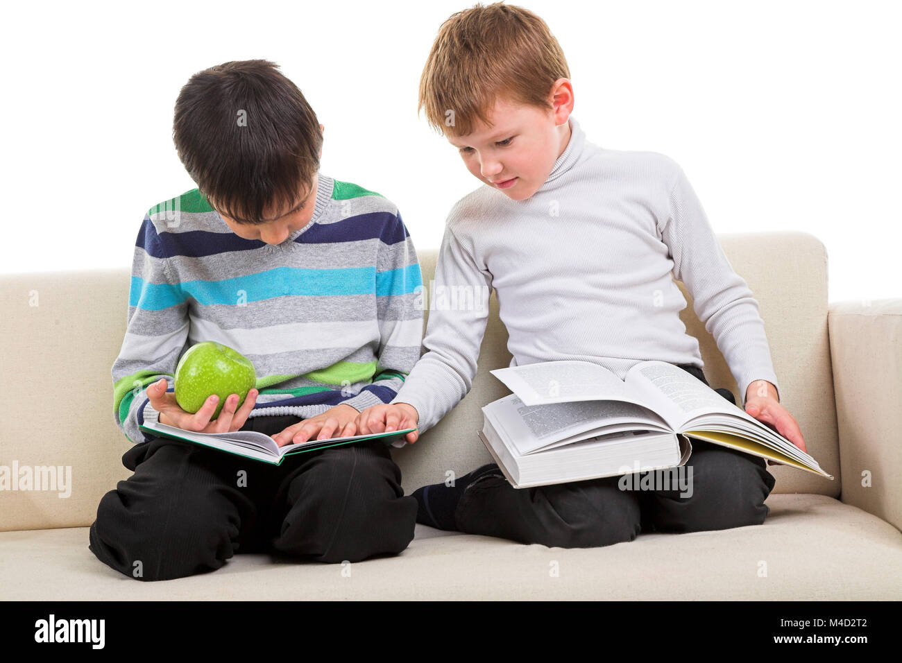 Two boys reading big book Stock Photo - Alamy