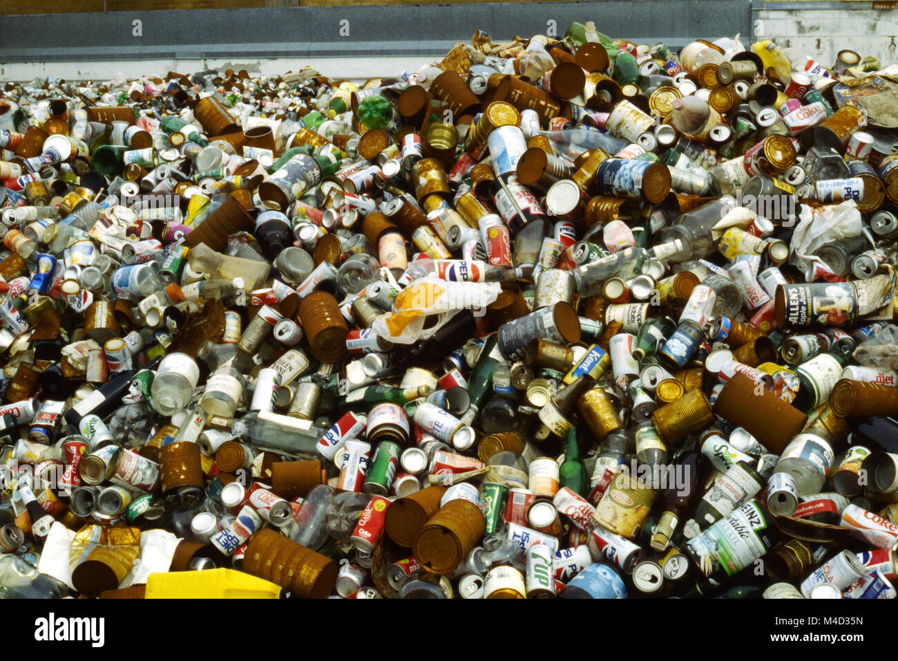 Cans glass and plastic containers being processed at a recycling plant ...
