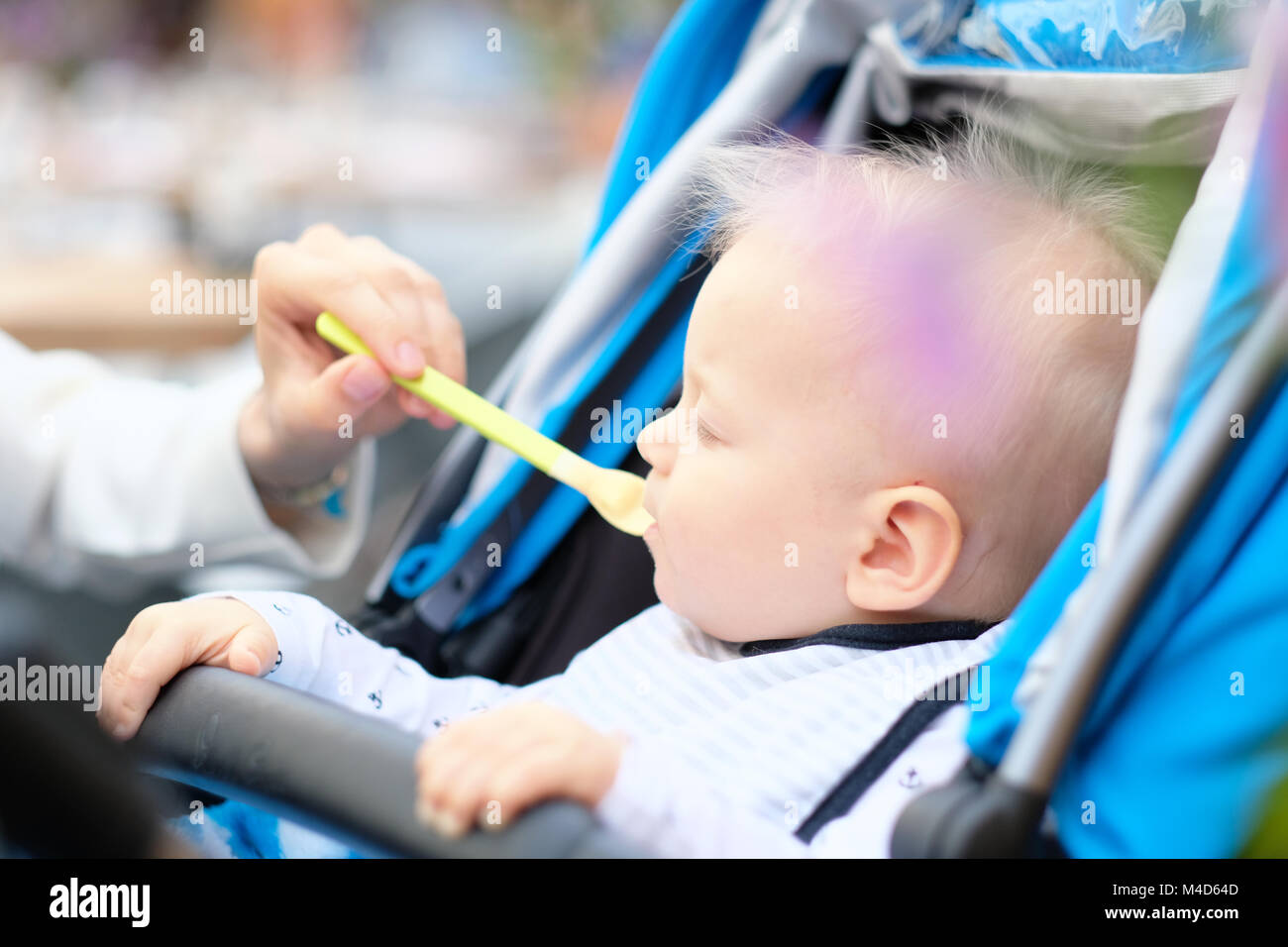 Baby boy sitting in modern stroller Stock Photo - Alamy
