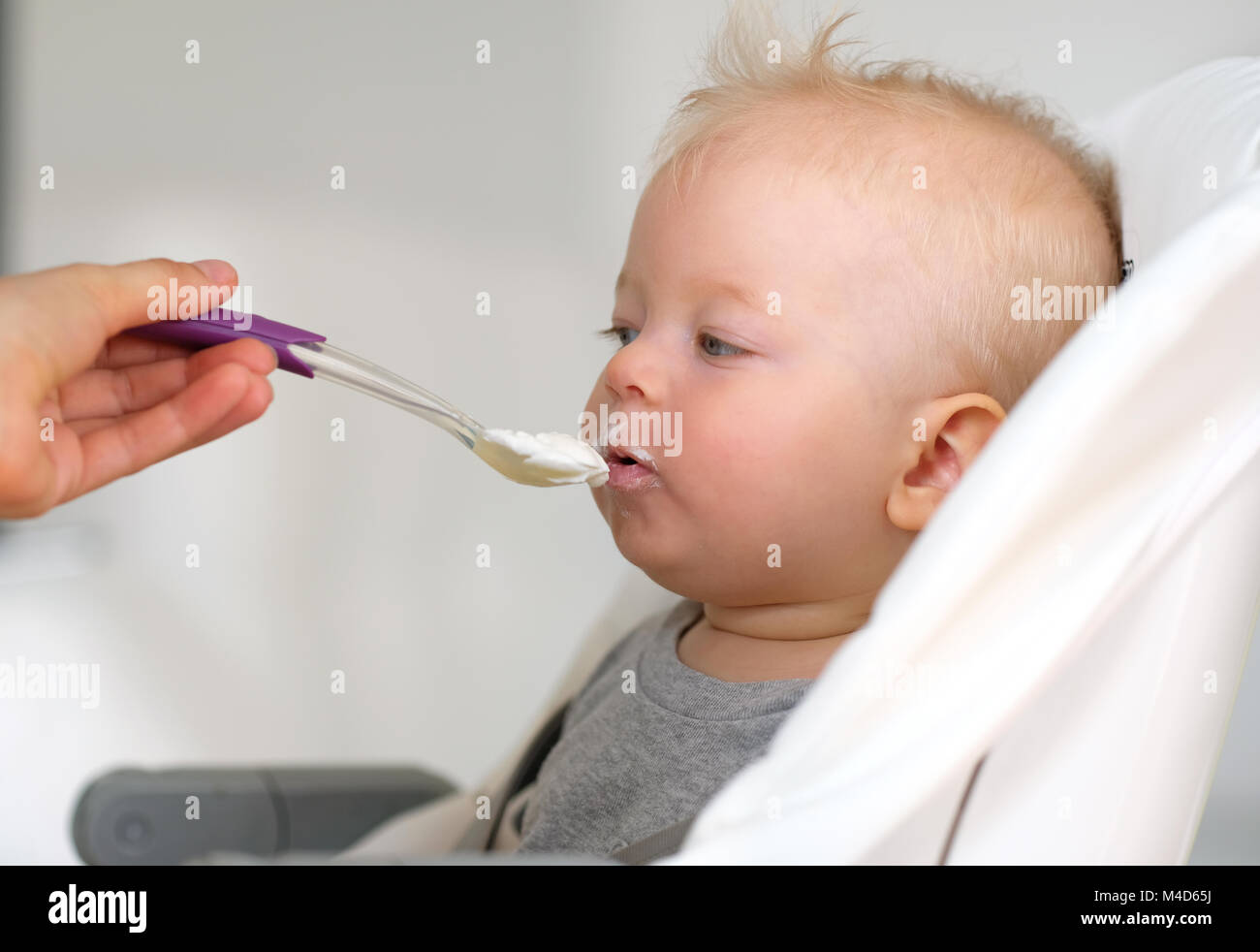 Feeding baby with spoon Stock Photo - Alamy
