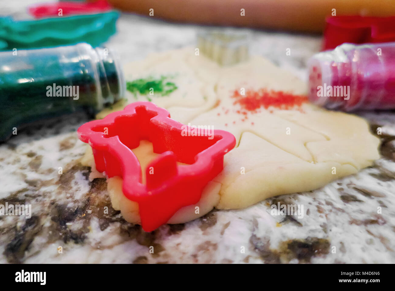 Red and green Sprinkles spilling out onto sugar cookie dough Stock ...