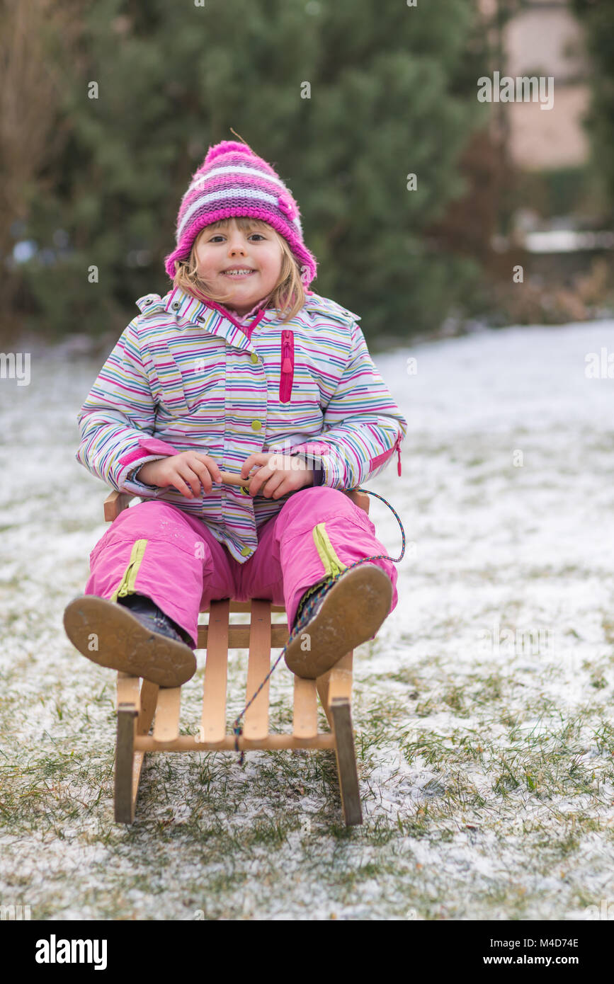 Girl with sleds in winter Stock Photo - Alamy