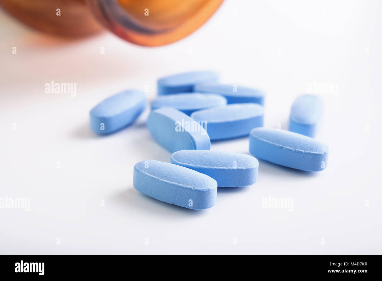 Blue pills on white Stock Photo - Alamy