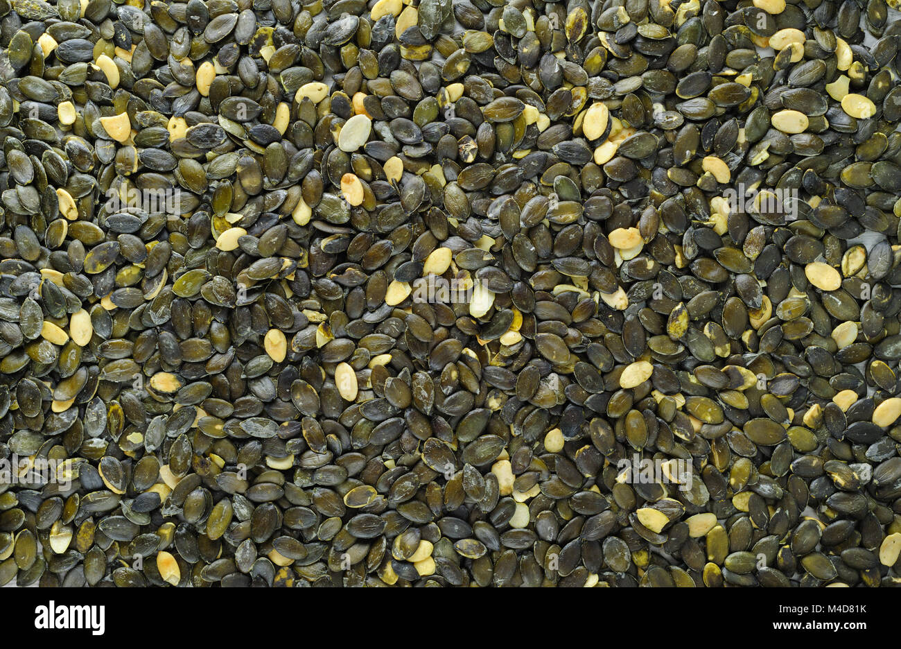 pumpkeen seeds scattered over stone board Stock Photo - Alamy