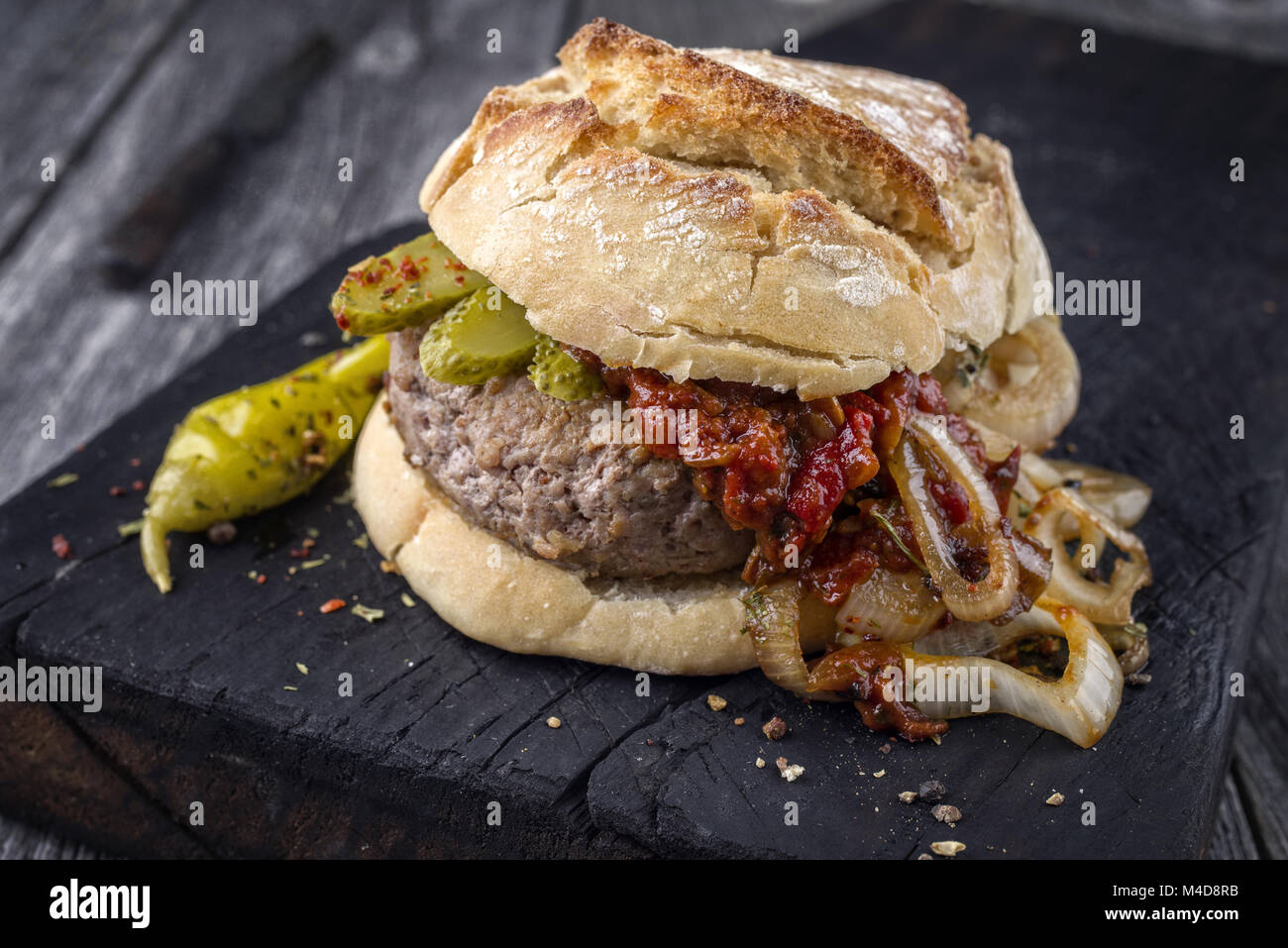Hamburger with Chili Relish on burnt Wood Stock Photo - Alamy