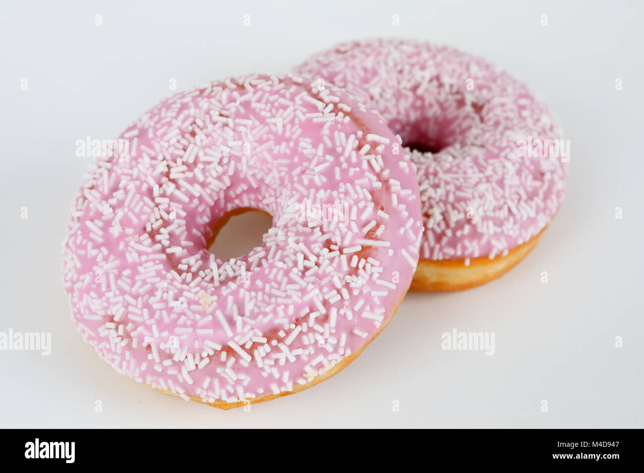 pink donut with sprinkles Stock Photo - Alamy