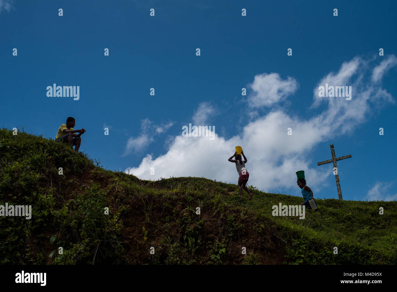 Young girls carry water from the river in an indigenous community in ...