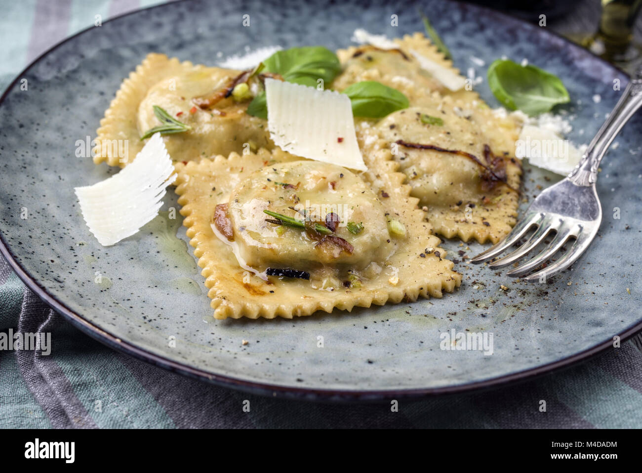 Ravioli with Parmesan on Plate Stock Photo - Alamy