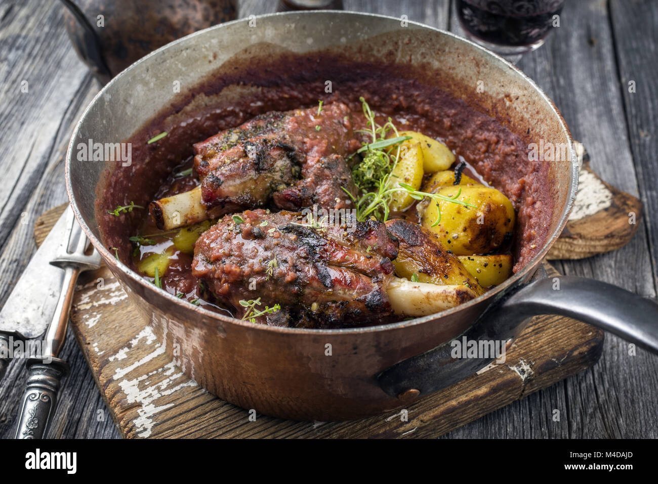 Lamb Knuckles with Fried Potatoes in Burgundy Sauce in Casserole Stock ...