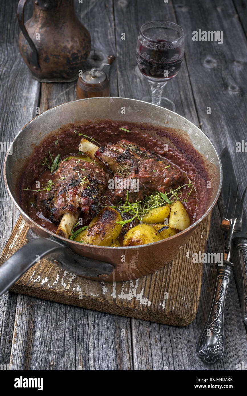 Lamb Knuckles with Potatoes in Burgundy Sauce in Casserole Stock Photo ...