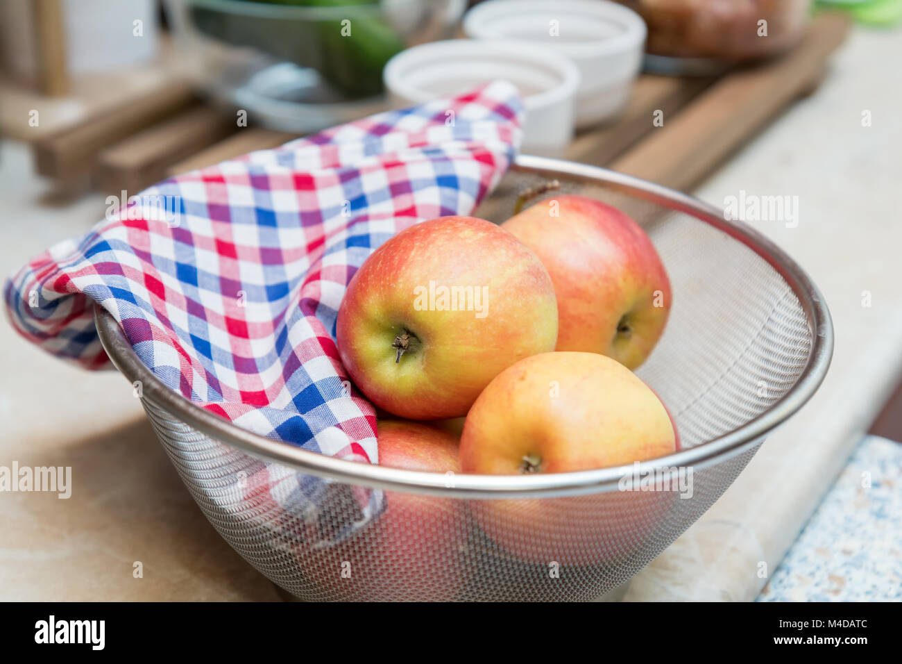 Raw fresh red apple with checkered napkin in sieve Stock Photo - Alamy