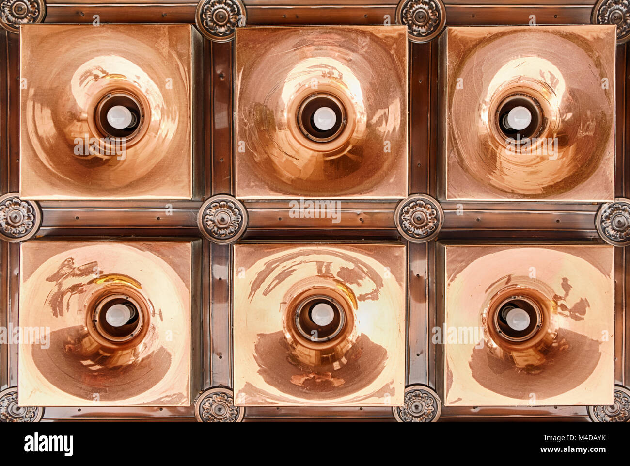 A custom copper light fixture creates an interesting pattern with six ...