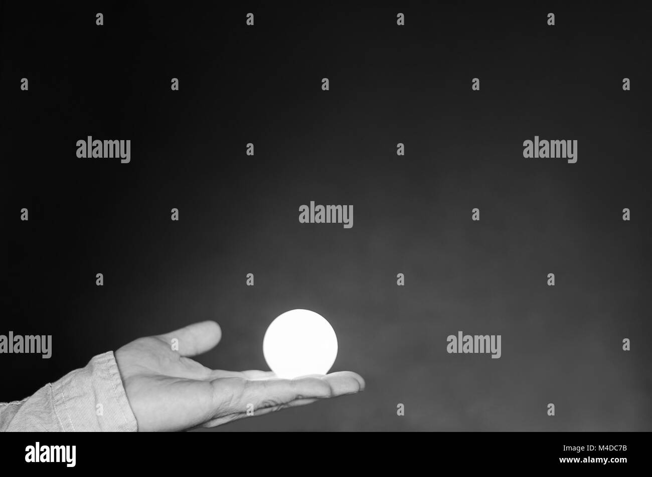 Hand with light bulb Stock Photo - Alamy