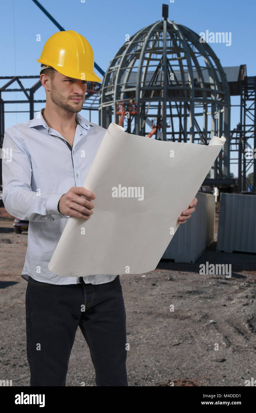 Construction Worker with Blueprints Stock Photo - Alamy