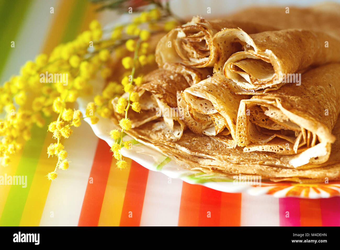 Closeup image of golden pancakes over colorful background Stock Photo ...