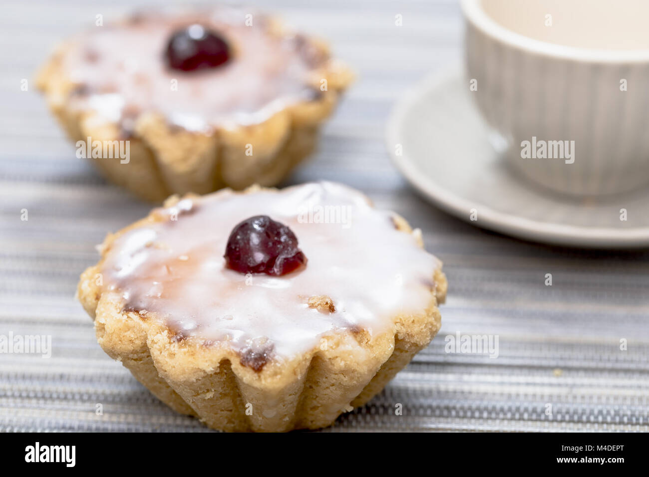 Marzipan pastry with sugar glaze and candied cherry Stock Photo - Alamy