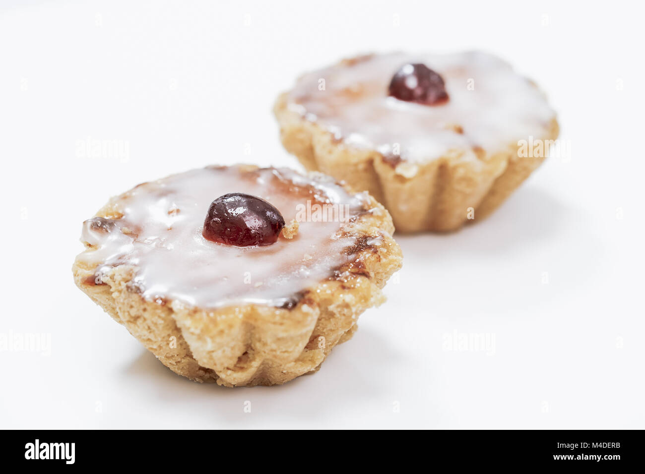 Marzipan pastry with sugar glaze and candied cherry Stock Photo - Alamy