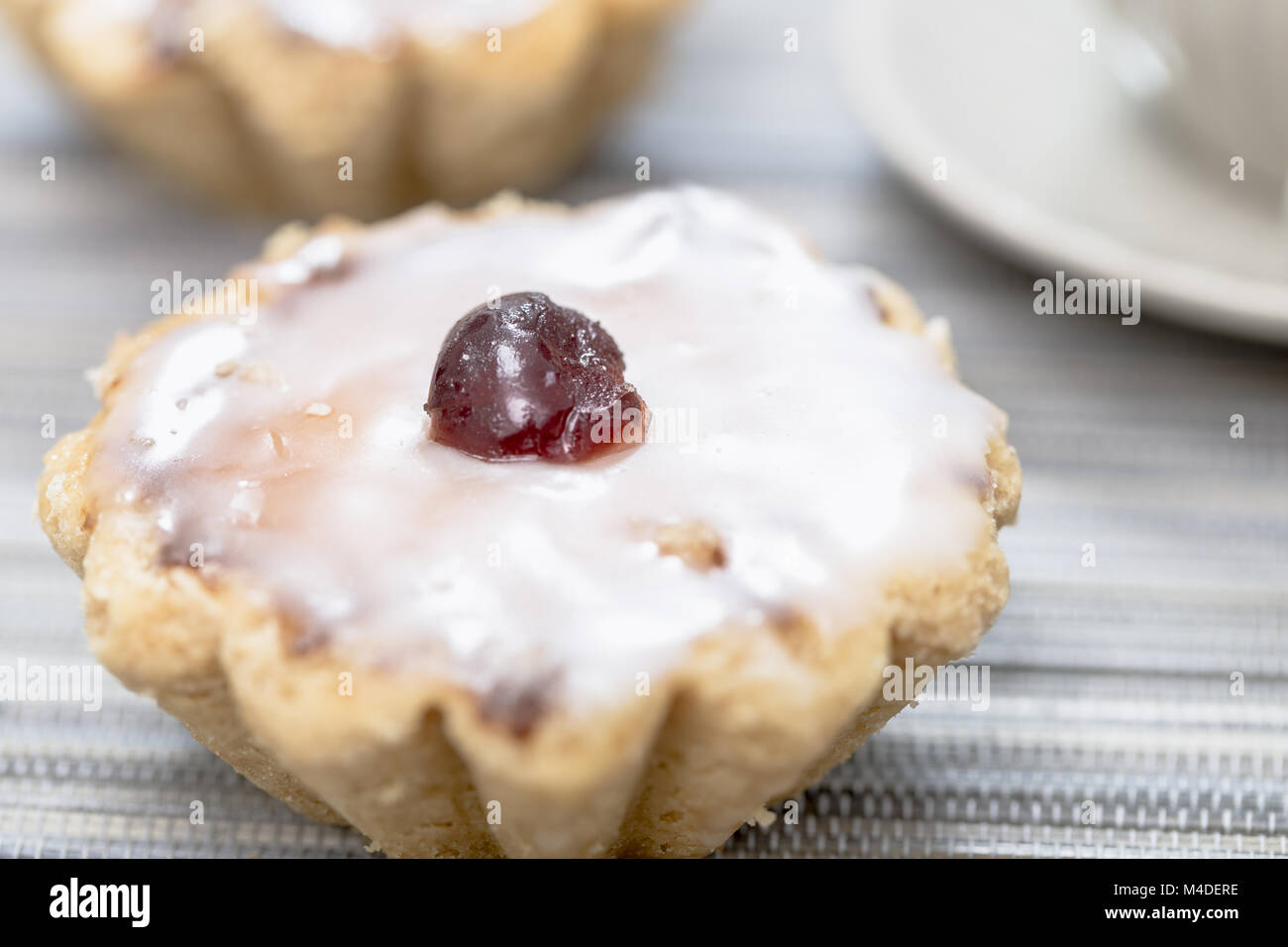 Marzipan pastry with sugar glaze and candied cherry Stock Photo - Alamy