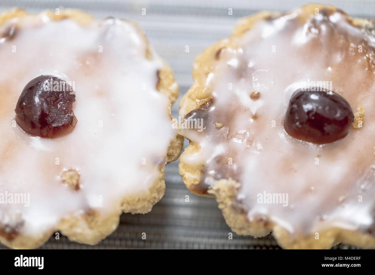 Marzipan pastry with sugar glaze and candied cherry Stock Photo - Alamy