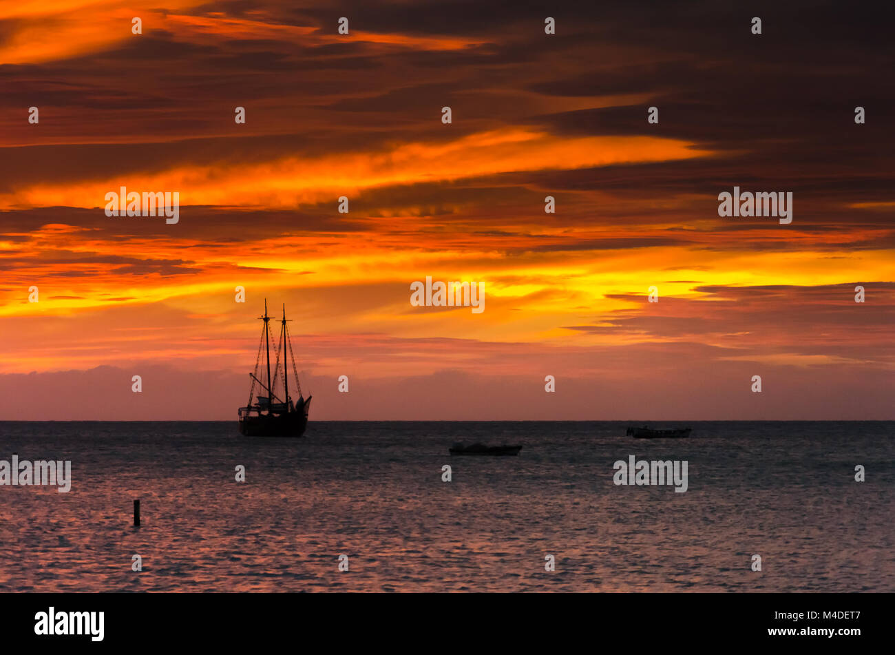 the Golden hour with sail boats on sea anchored Stock Photo - Alamy