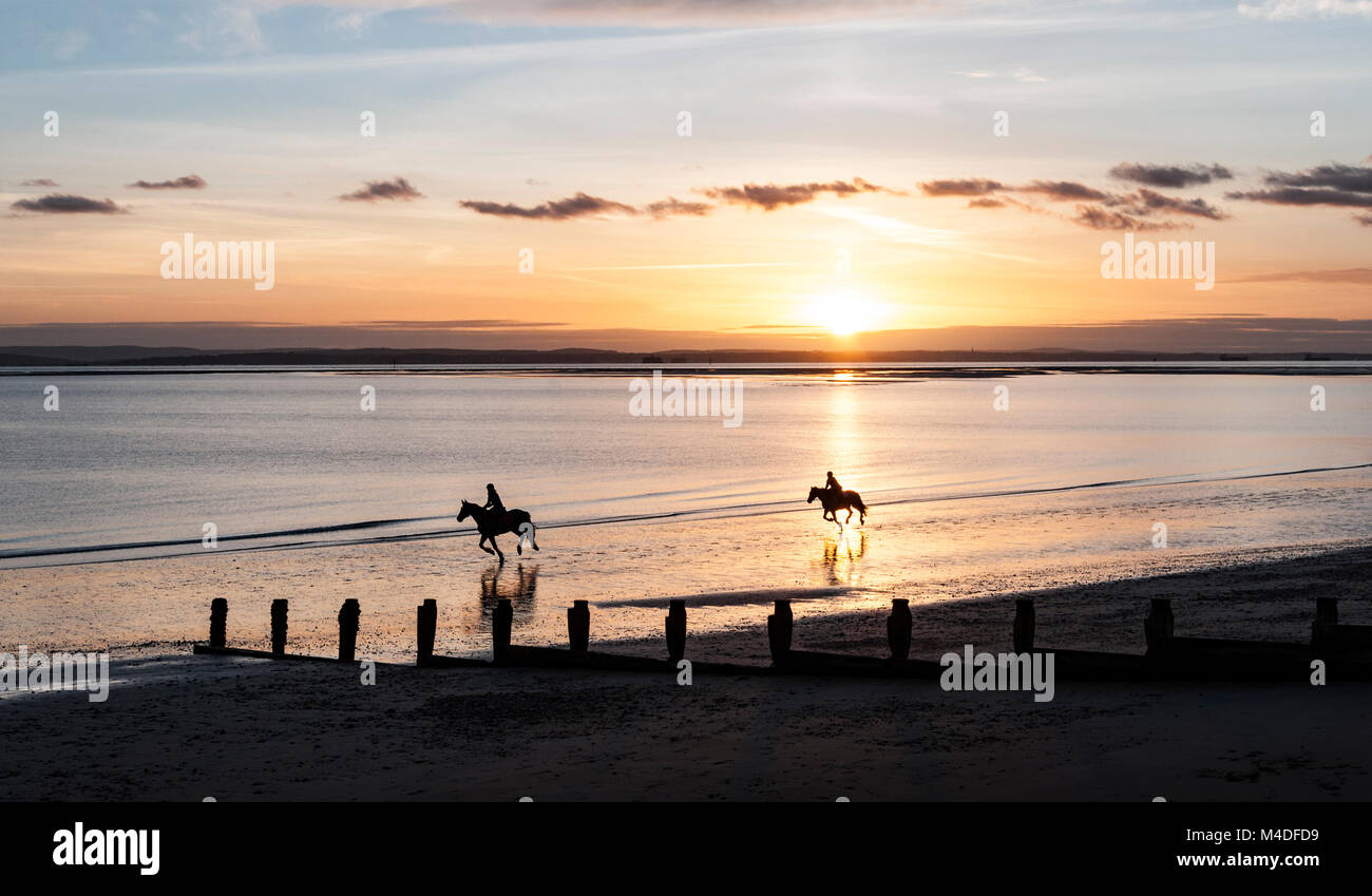 Riding horses at sunset hi-res stock photography and images - Alamy