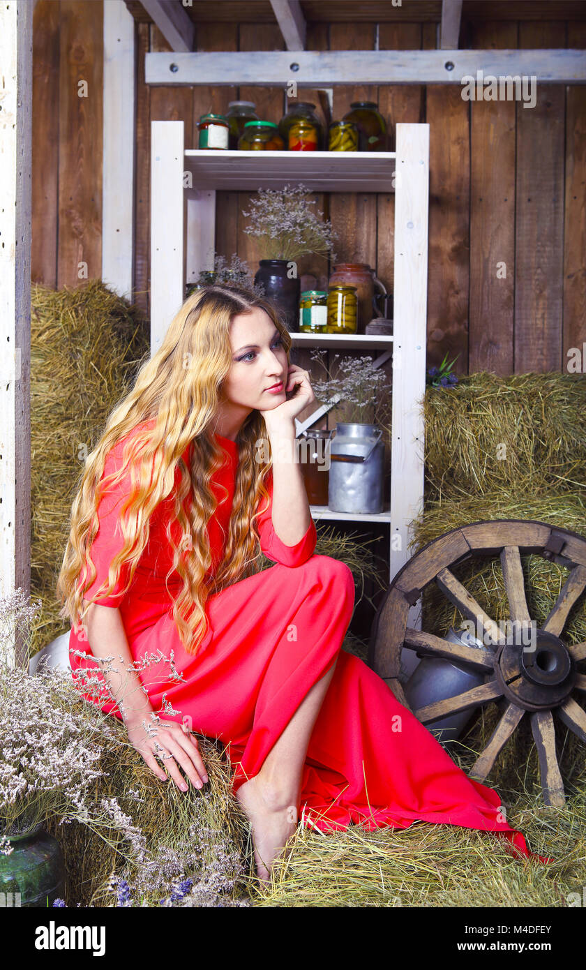 Beautiful blond fashionable woman on hay barn Stock Photo - Alamy