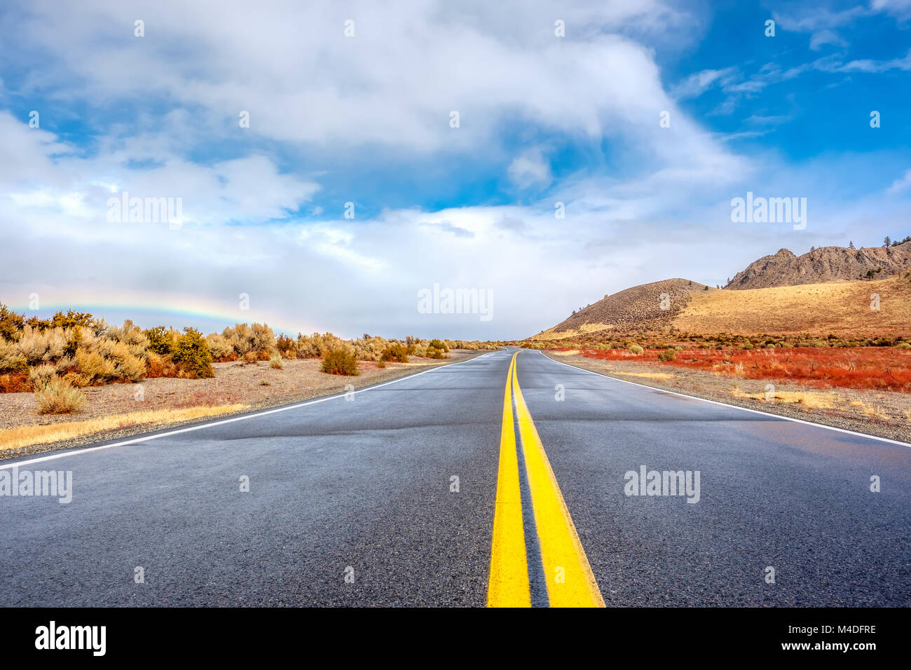 Open highway and rainbow Stock Photo - Alamy