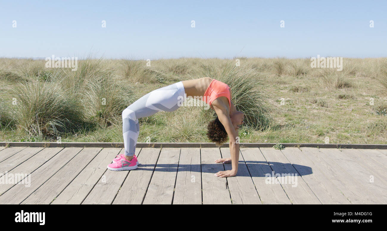 Woman in bridge position Stock Photo - Alamy