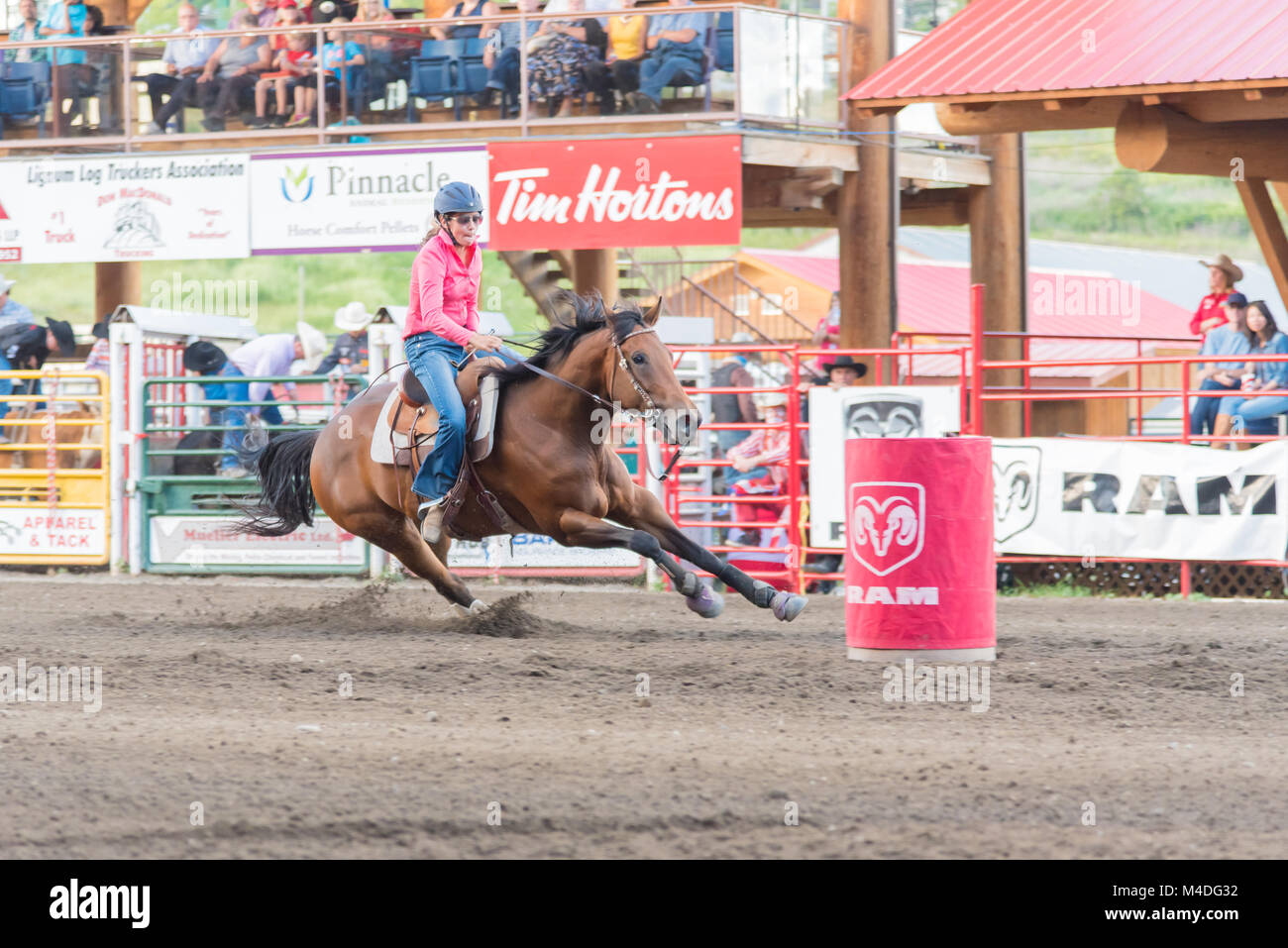 Horse and rider approach next barrel during a barrel racing competition ...