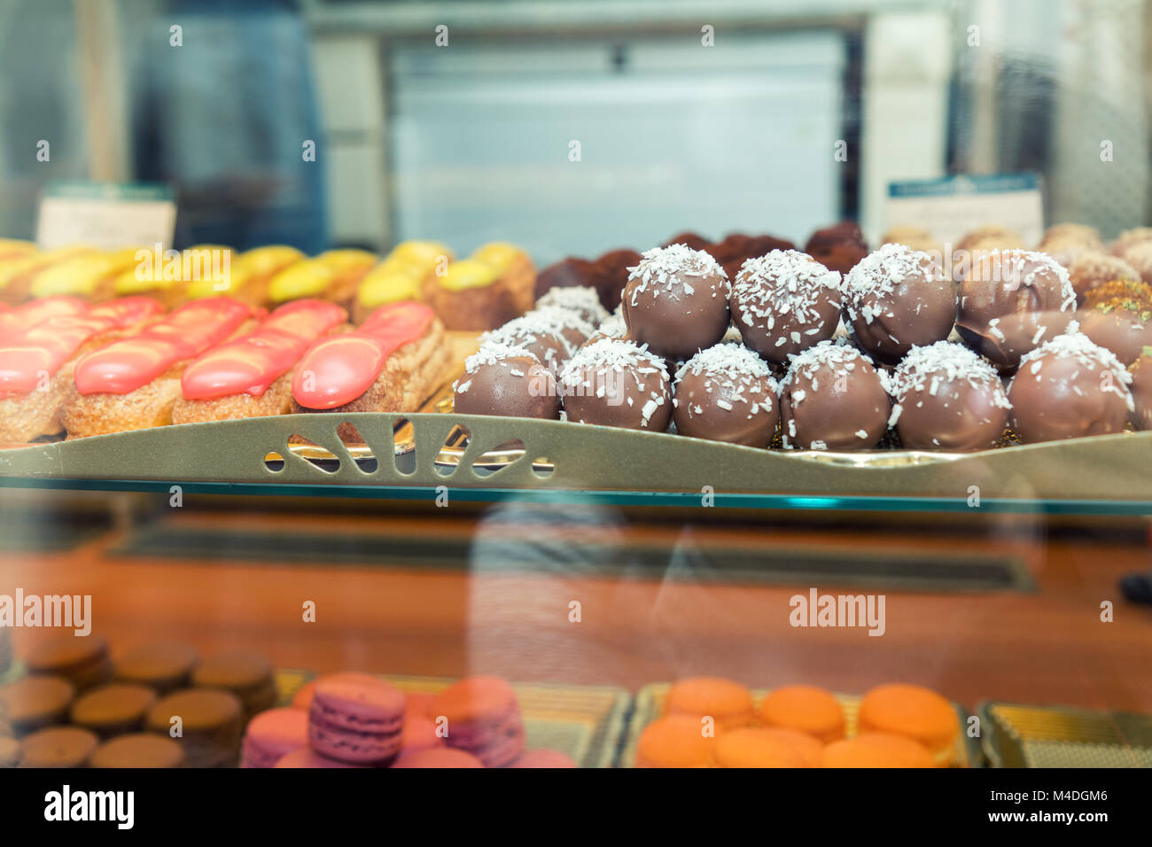 Chocolate balls and eclairs cakes Stock Photo - Alamy
