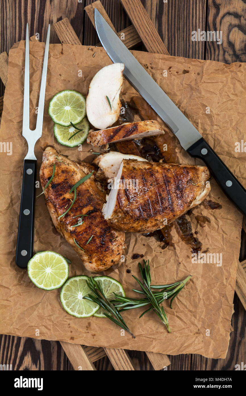 Grilled chicken filet with herbs on a paper Stock Photo - Alamy