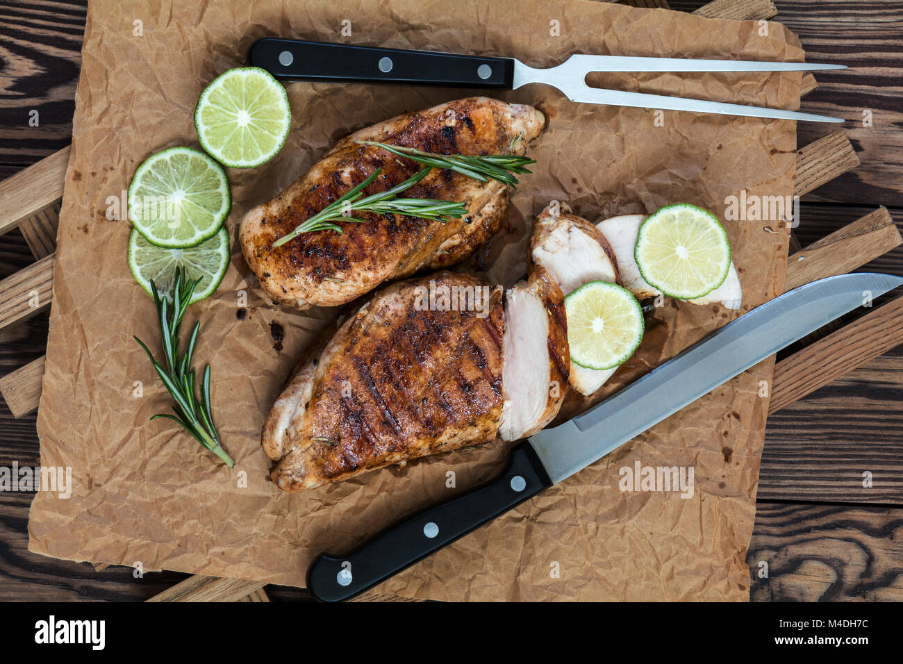 Grilled chicken filet with herbs on a paper Stock Photo - Alamy