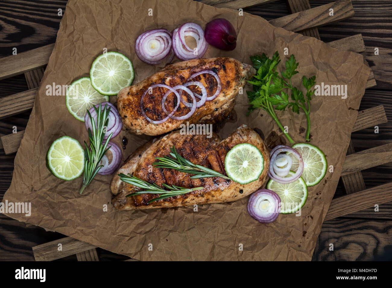 Grilled chicken filet with herbs on a paper Stock Photo - Alamy