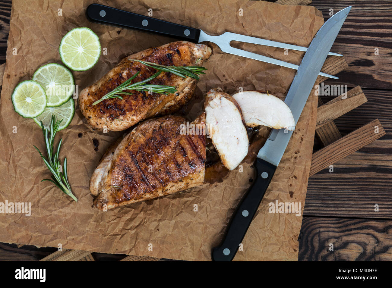 Grilled chicken filet with herbs on a paper Stock Photo - Alamy
