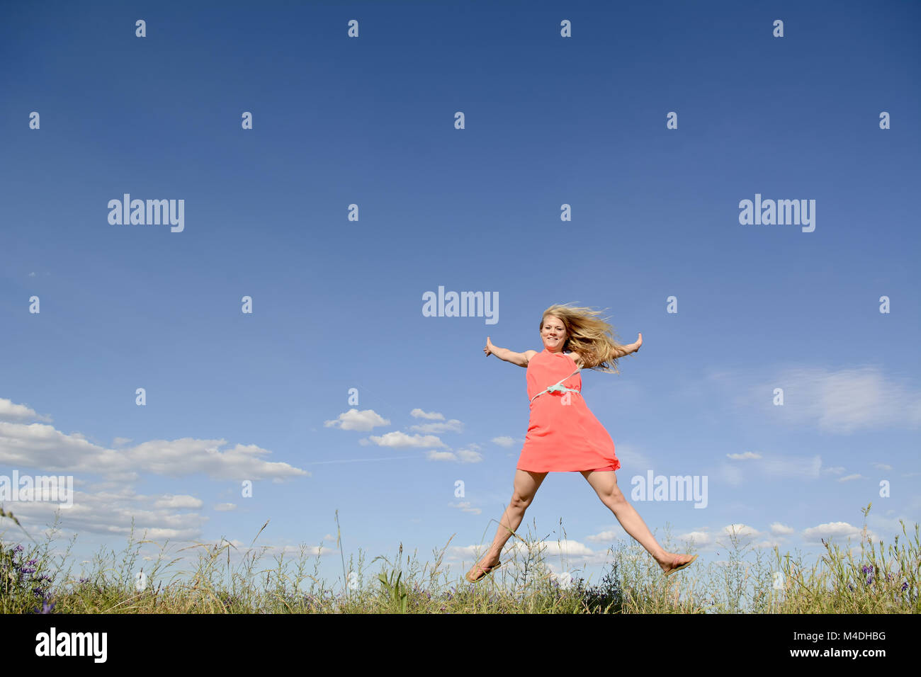 blond woman leaping Stock Photo - Alamy