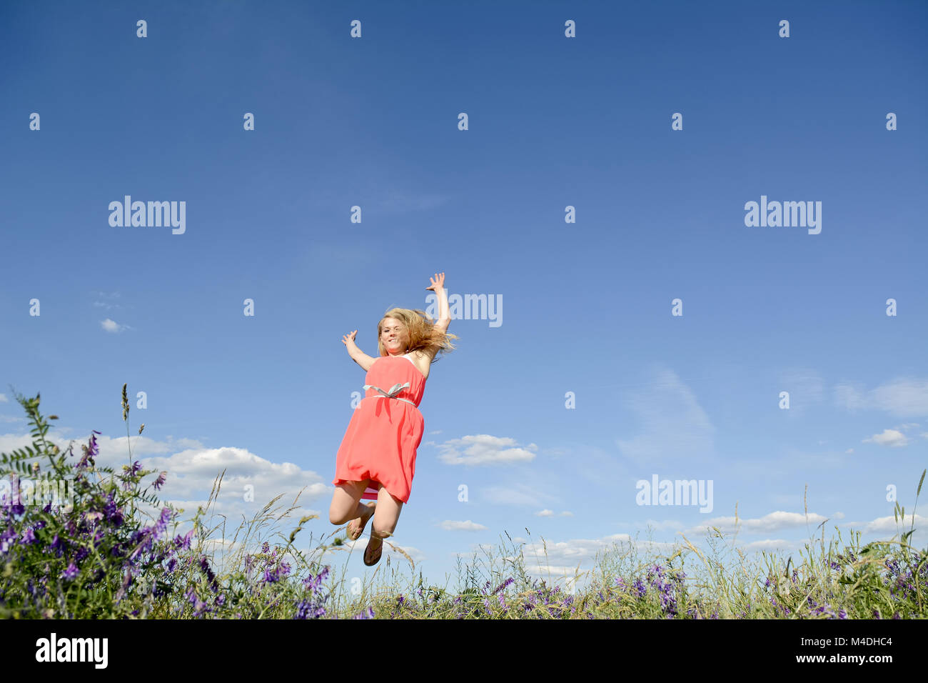 blond woman leaping Stock Photo - Alamy