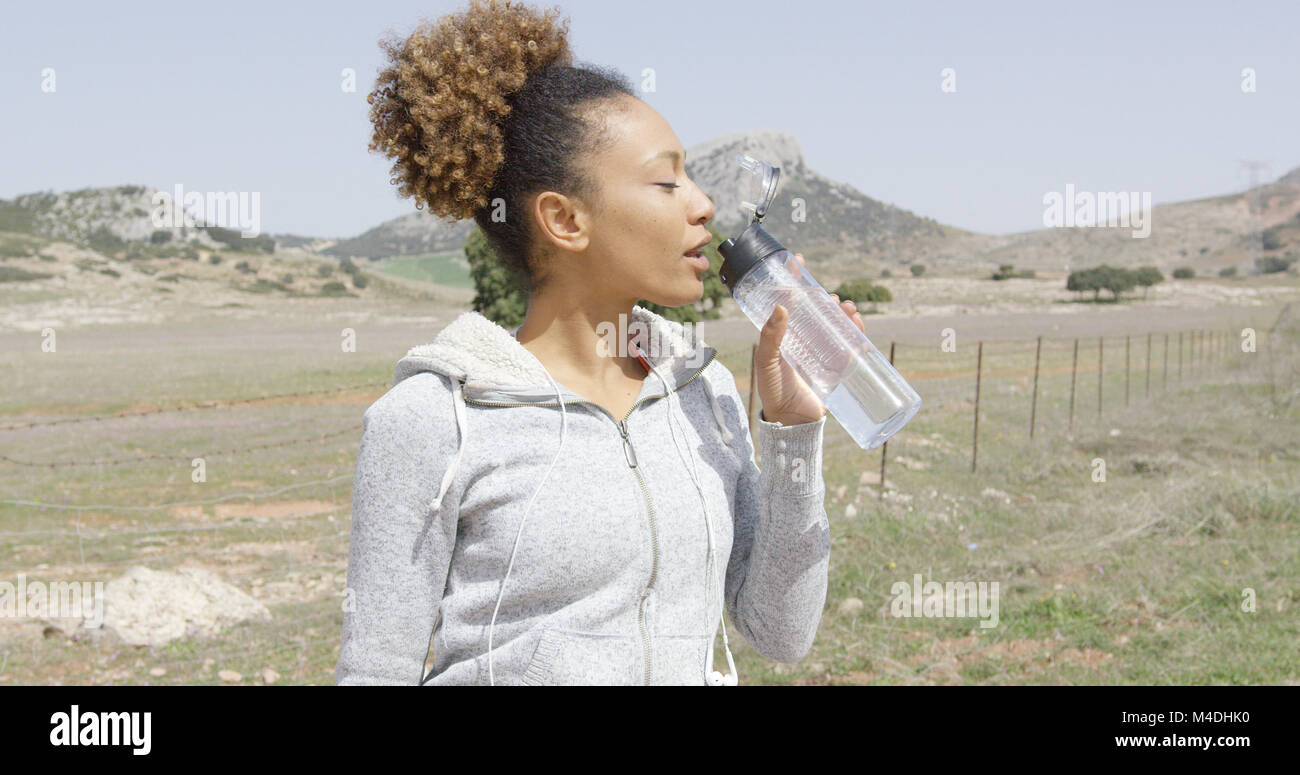 Female drinking water during workout Stock Photo - Alamy