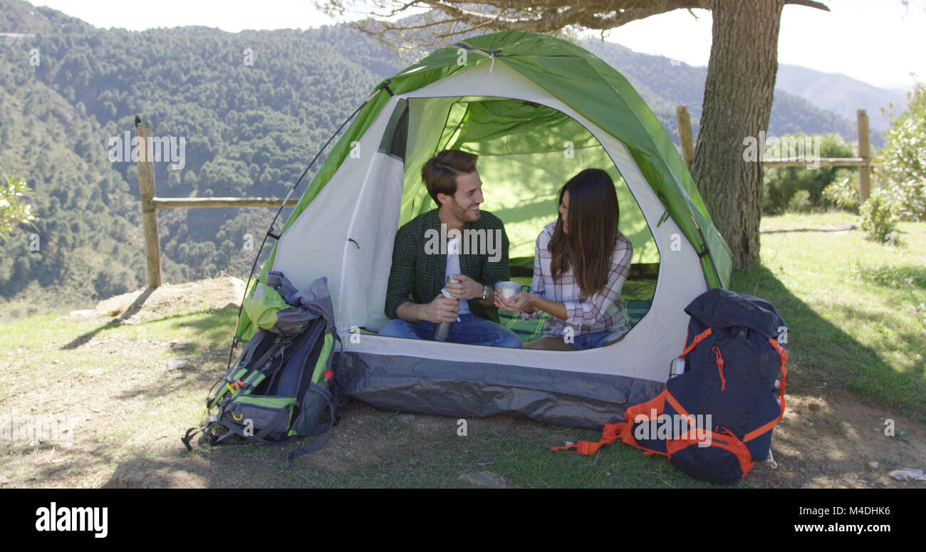 Two people having rest in tent Stock Photo - Alamy