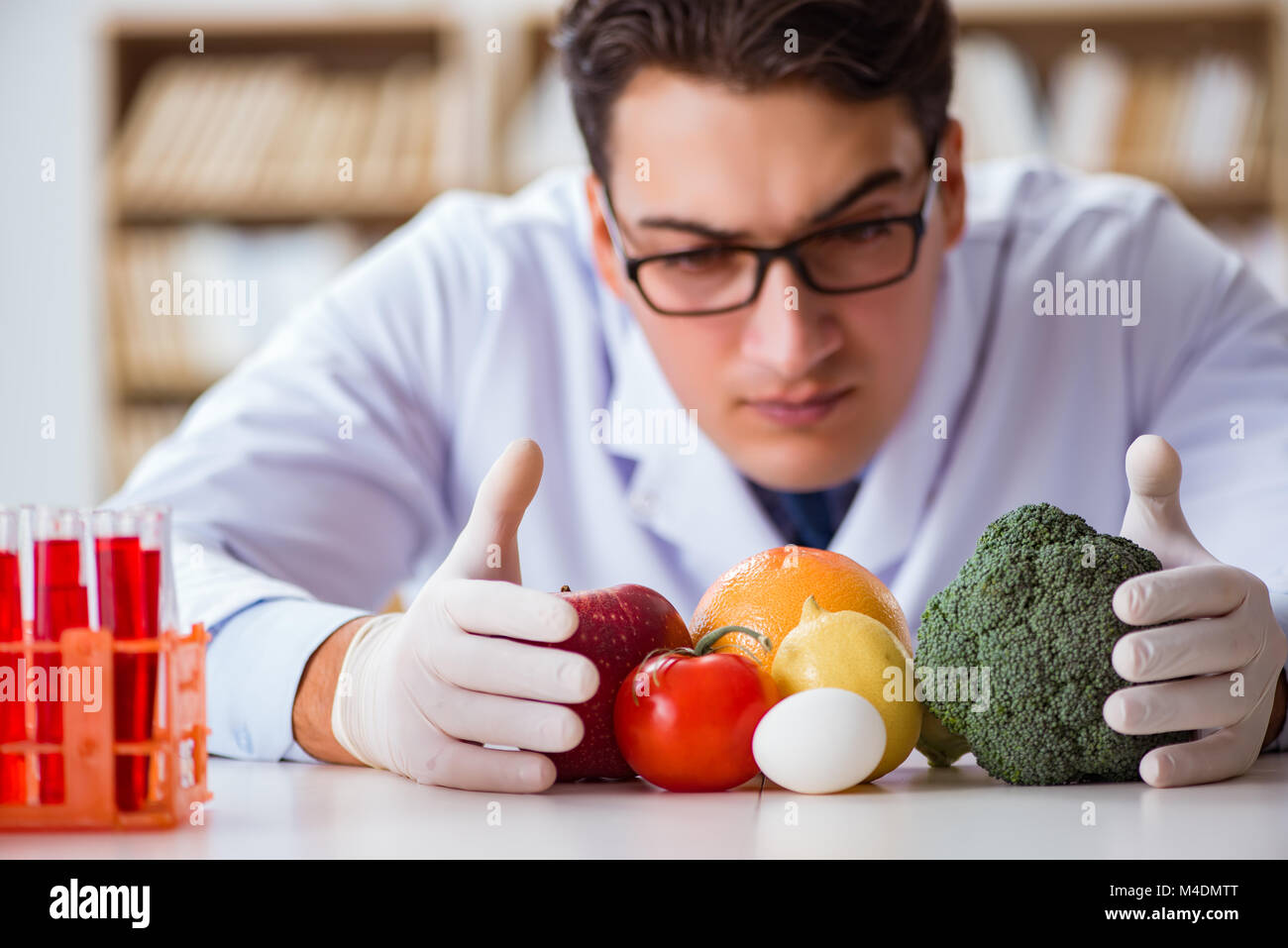The man doctor checking the fruits and vegetables Stock Photo - Alamy