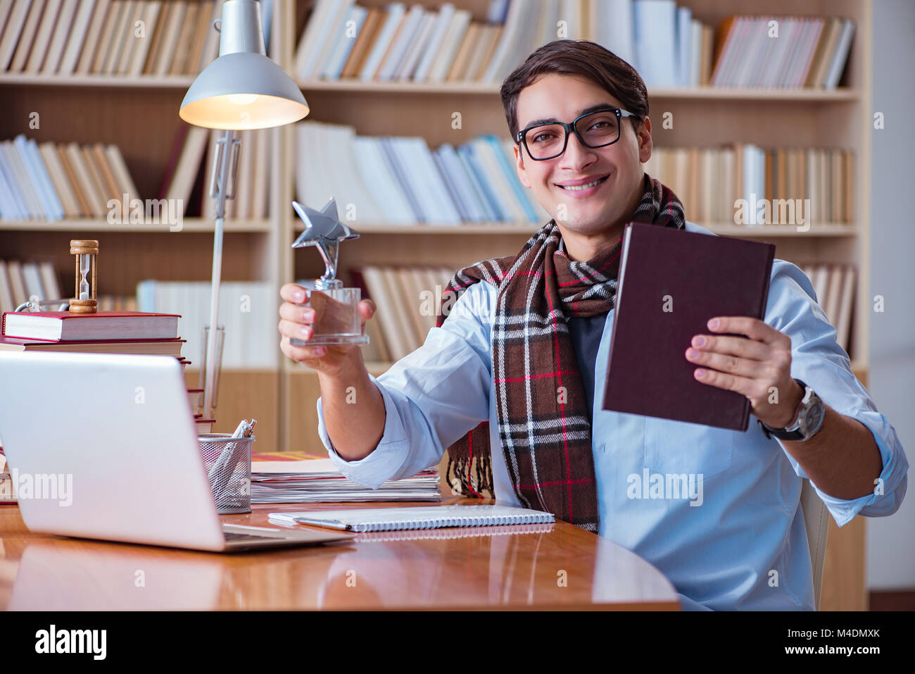 The young book writer writing in library Stock Photo - Alamy