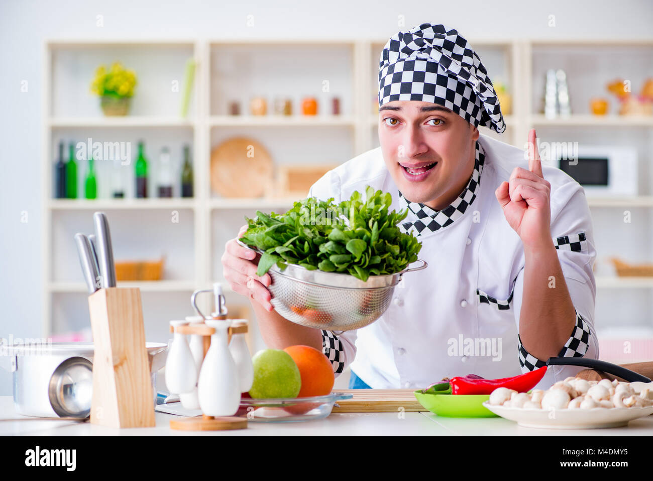 The young male cook working in the kitchen Stock Photo - Alamy