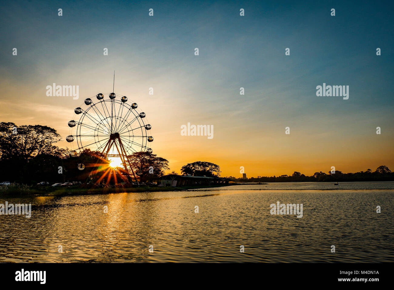 Ferris wheel silhouetted at sunset on Inya Lake in Yangon Myanmar Stock ...