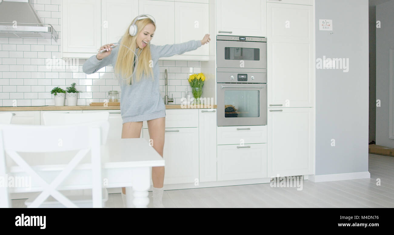 Expressive young girl dancing in kitchen Stock Photo - Alamy