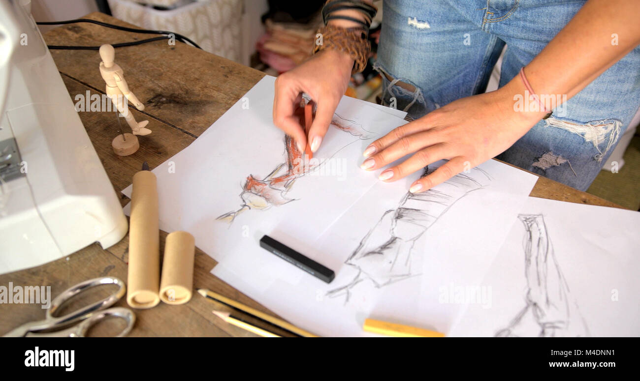Tailor drawing sketches Stock Photo - Alamy