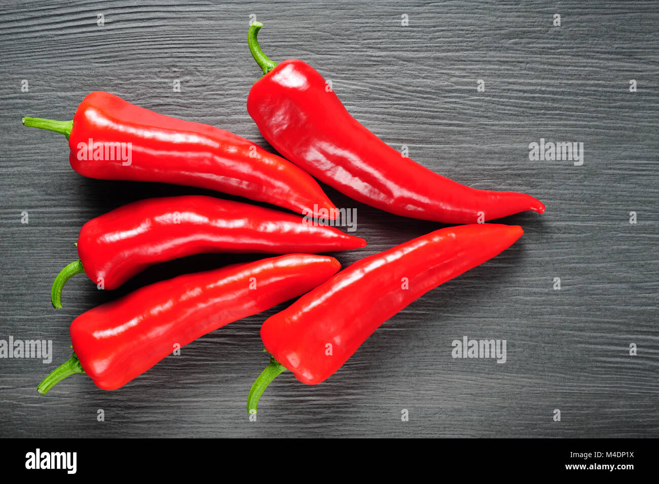 Sweet red Kapia peppers on a dark shale stone background Stock Photo ...