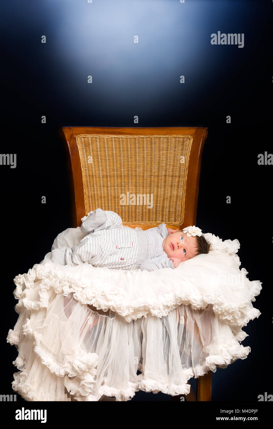 Newborn baby girl with sleeping on a wooden chair Stock Photo - Alamy