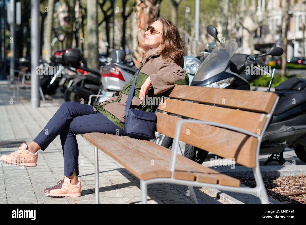 Woman at the street, sitting on bench, Barcelona Stock Photo - Alamy