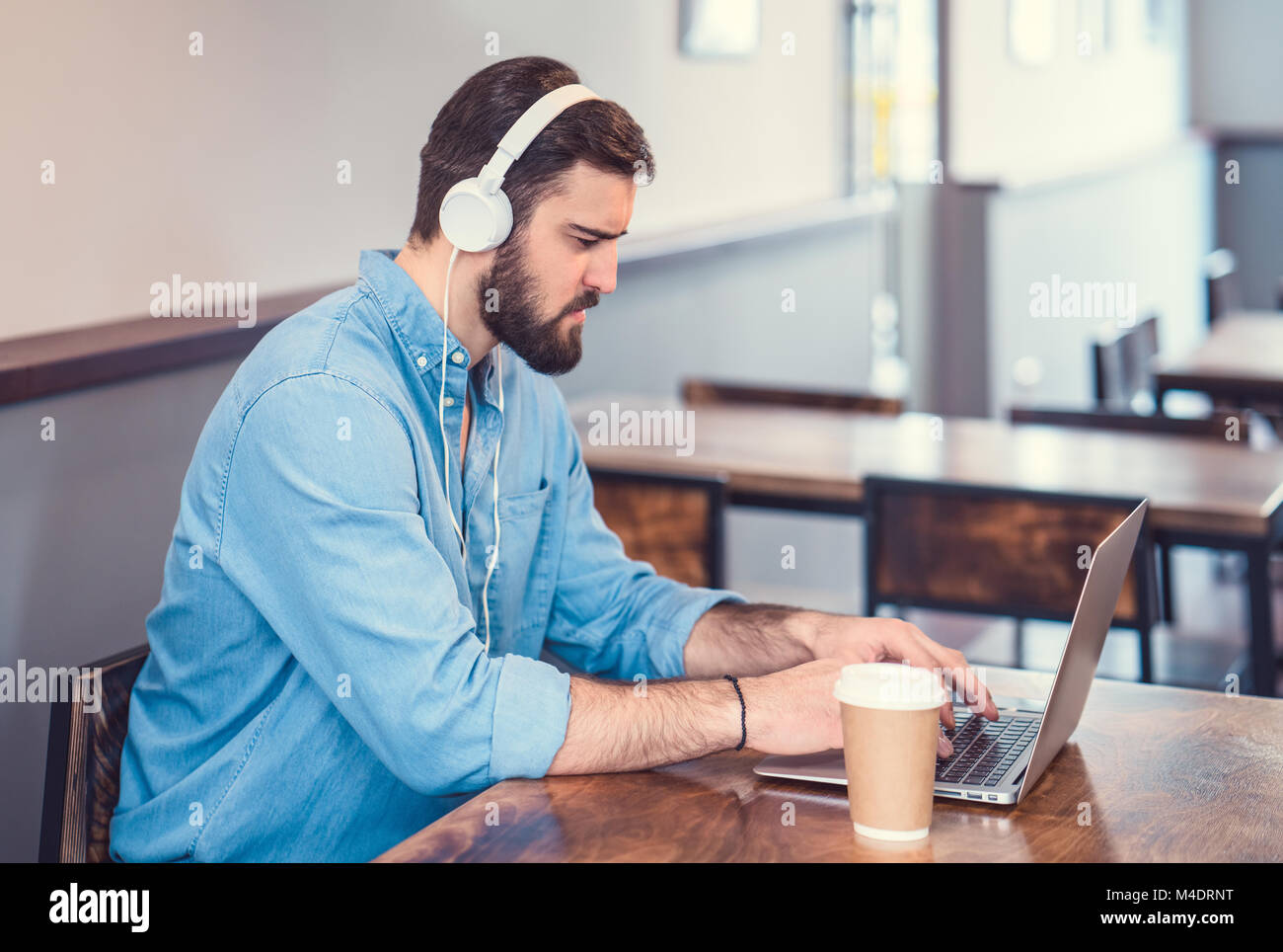 Young man in cafe Stock Photo - Alamy