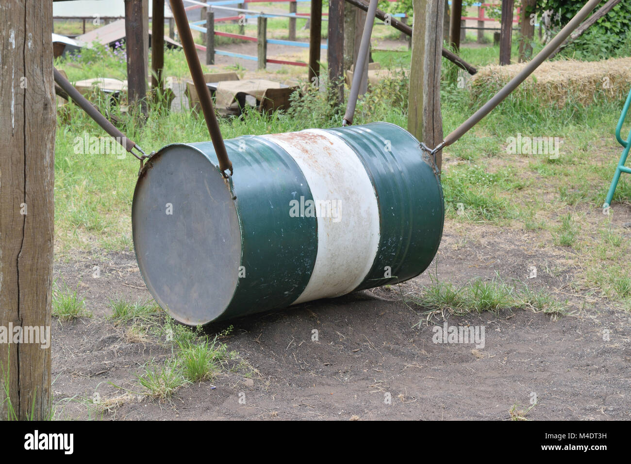 old oil barrel turned into the swing Stock Photo - Alamy